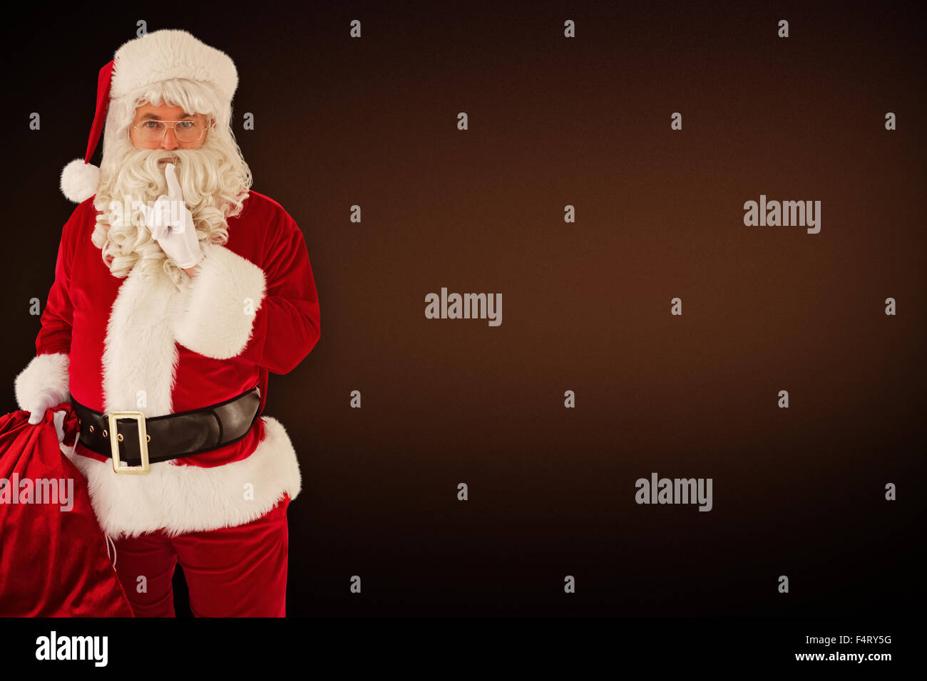 Composite image of santa holding his sack and keeping a secret Stock ...
