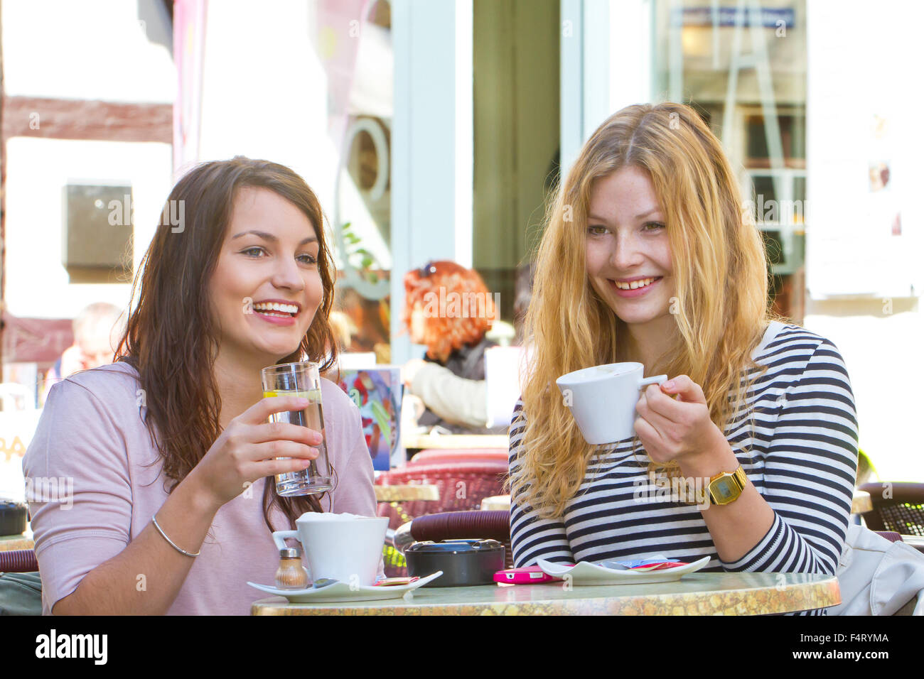Two girls an street cafe Stock Photo - Alamy
