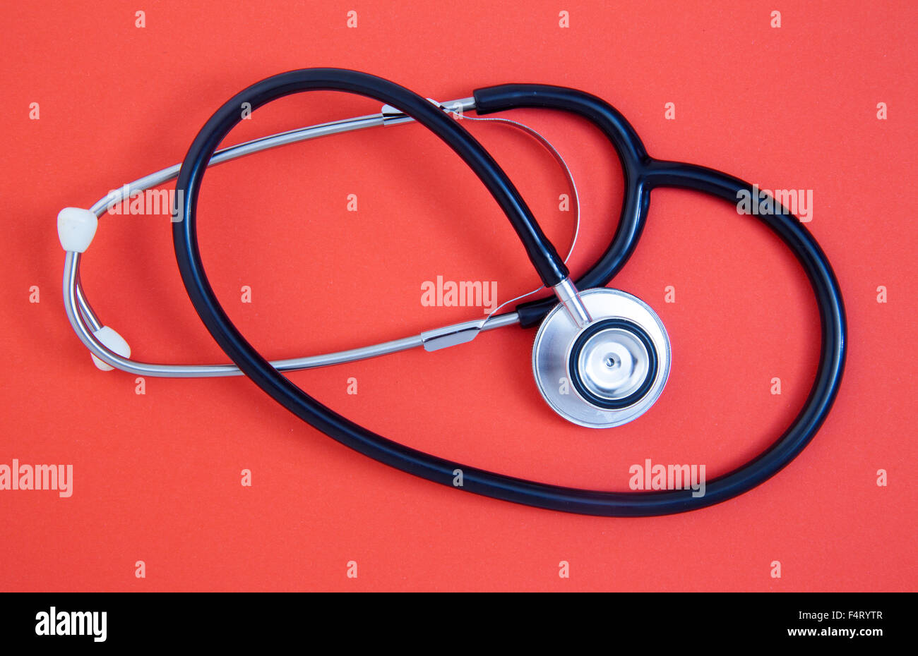 Standard stethoscope on red background Stock Photo - Alamy