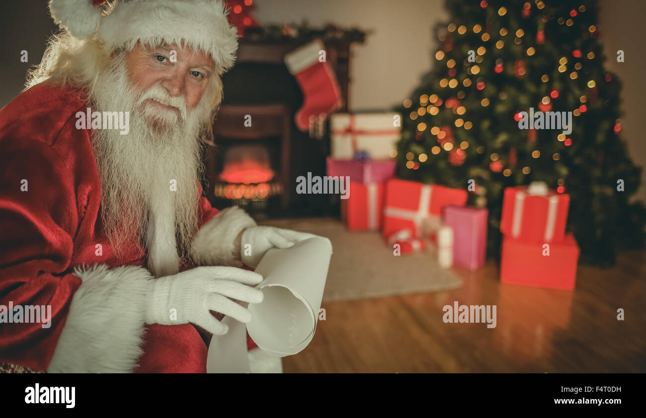 Smiling santa claus holding a scroll Stock Photo - Alamy