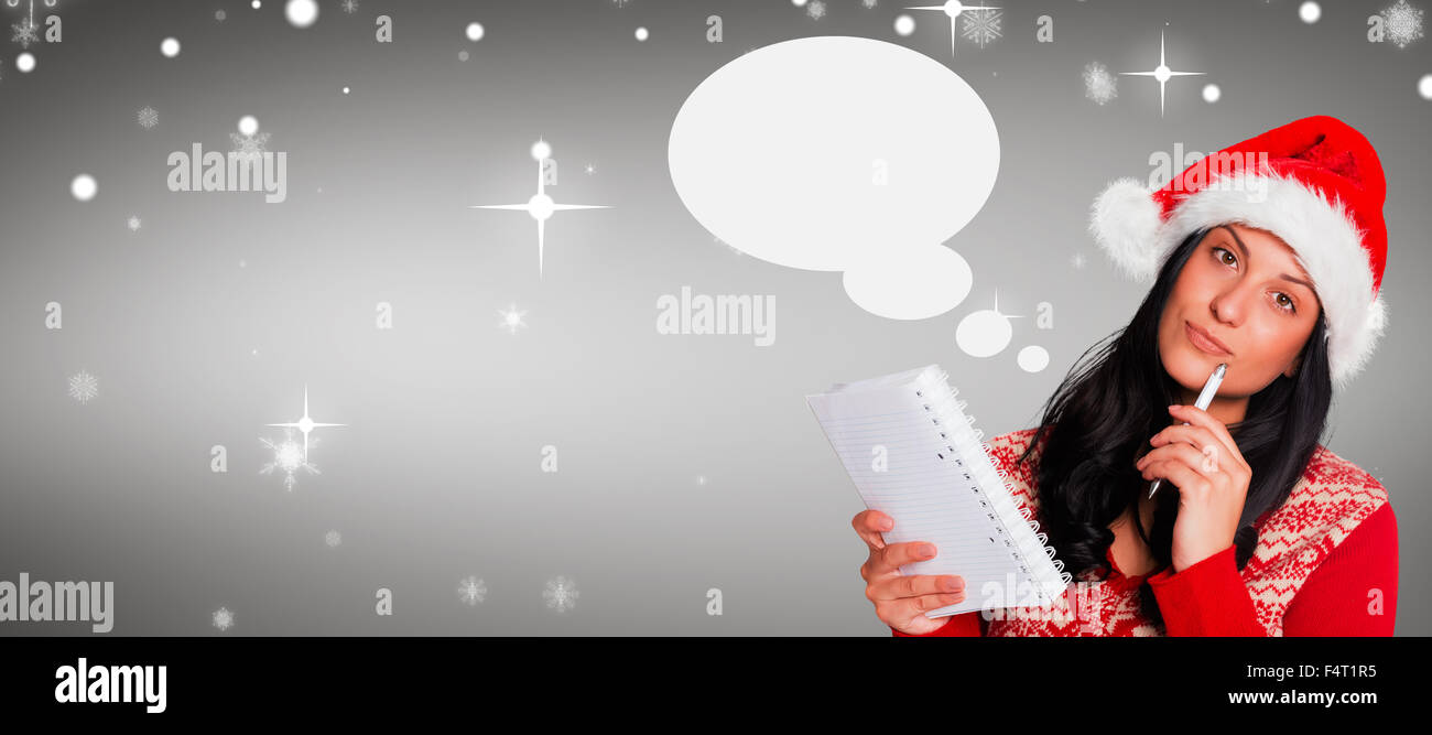Composite image of woman thinking what to write Stock Photo - Alamy