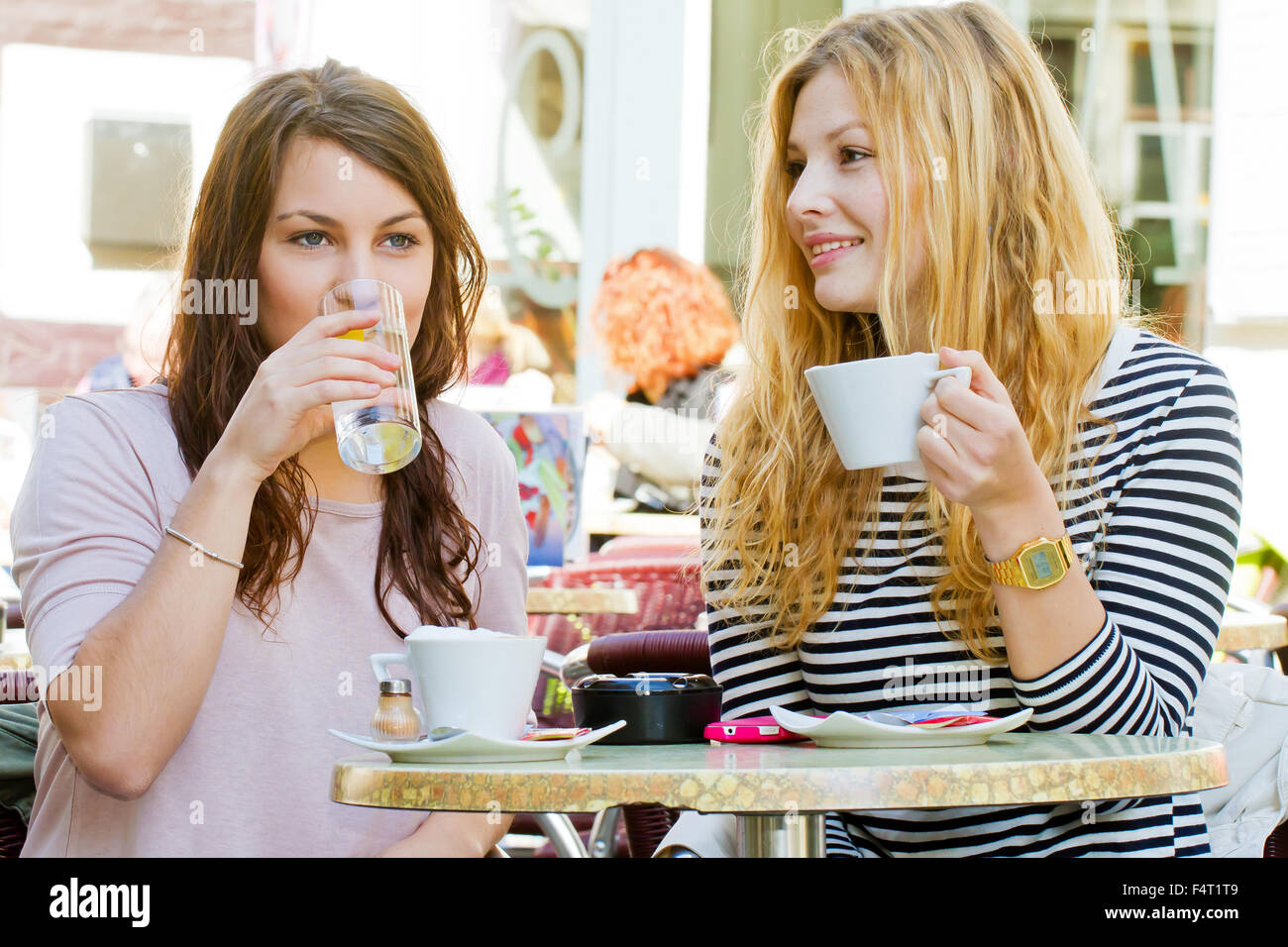 Two girls an street cafe Stock Photo - Alamy