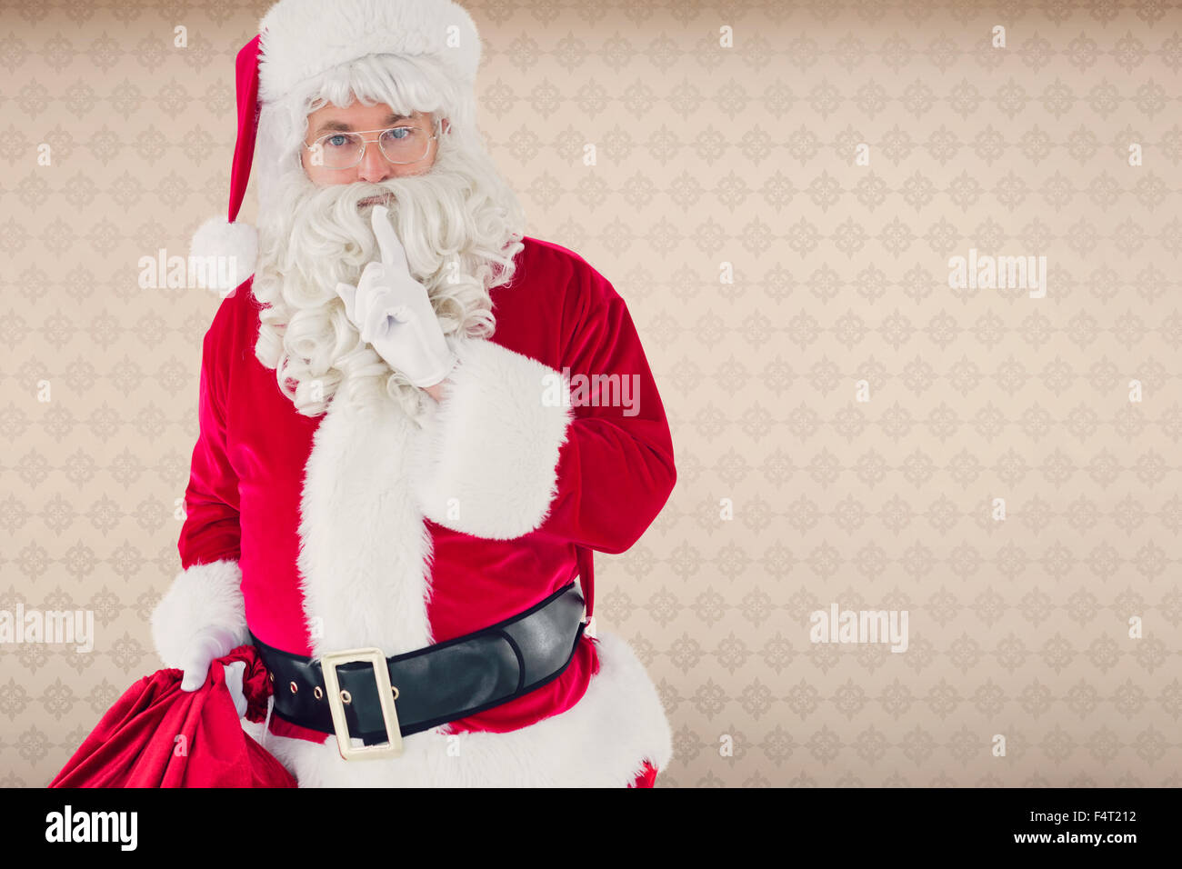 Composite image of santa holding his sack and keeping a secret Stock ...