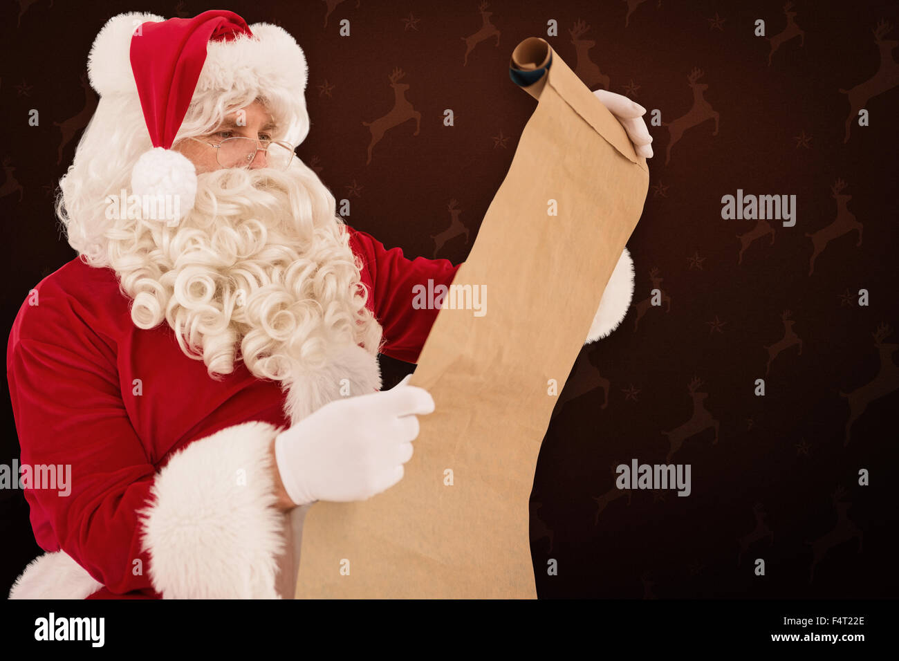 Composite image of santa checking list Stock Photo - Alamy