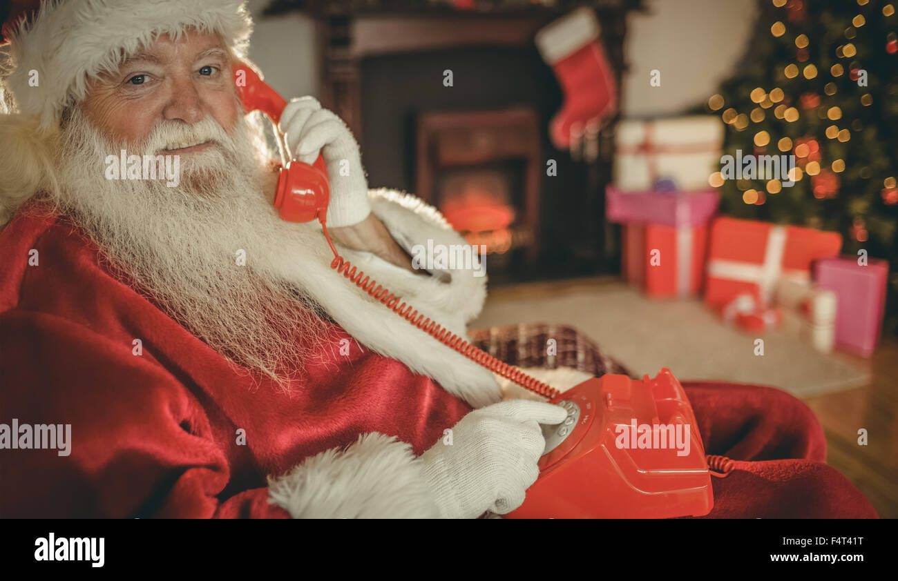 Smiling santa making a phone call Stock Photo - Alamy