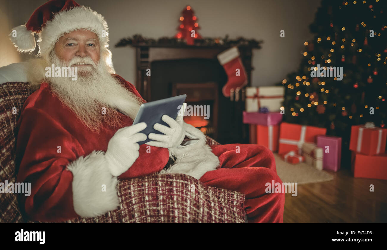 Happy santa using tablet hi-res stock photography and images - Alamy