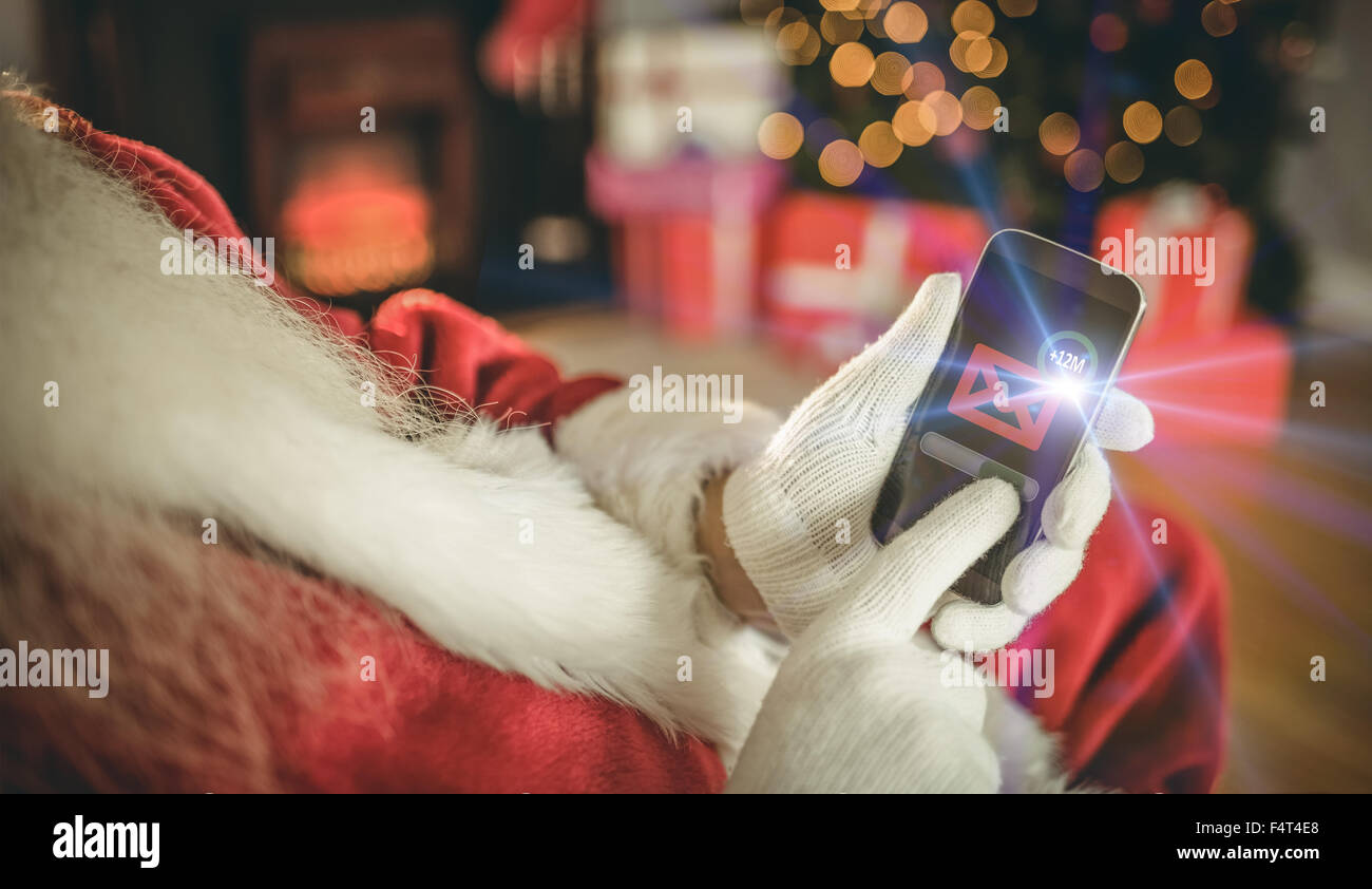 Santa claus touching a smartphone at christmas Stock Photo - Alamy