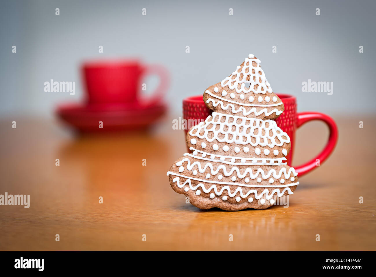gingerbread cookie standing next to red cup Stock Photo - Alamy
