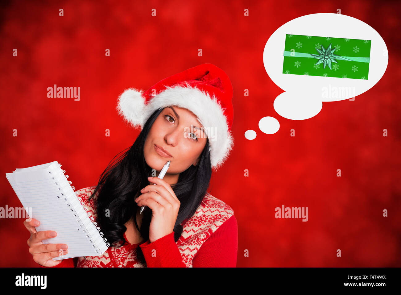 Composite image of woman thinking what to write Stock Photo - Alamy