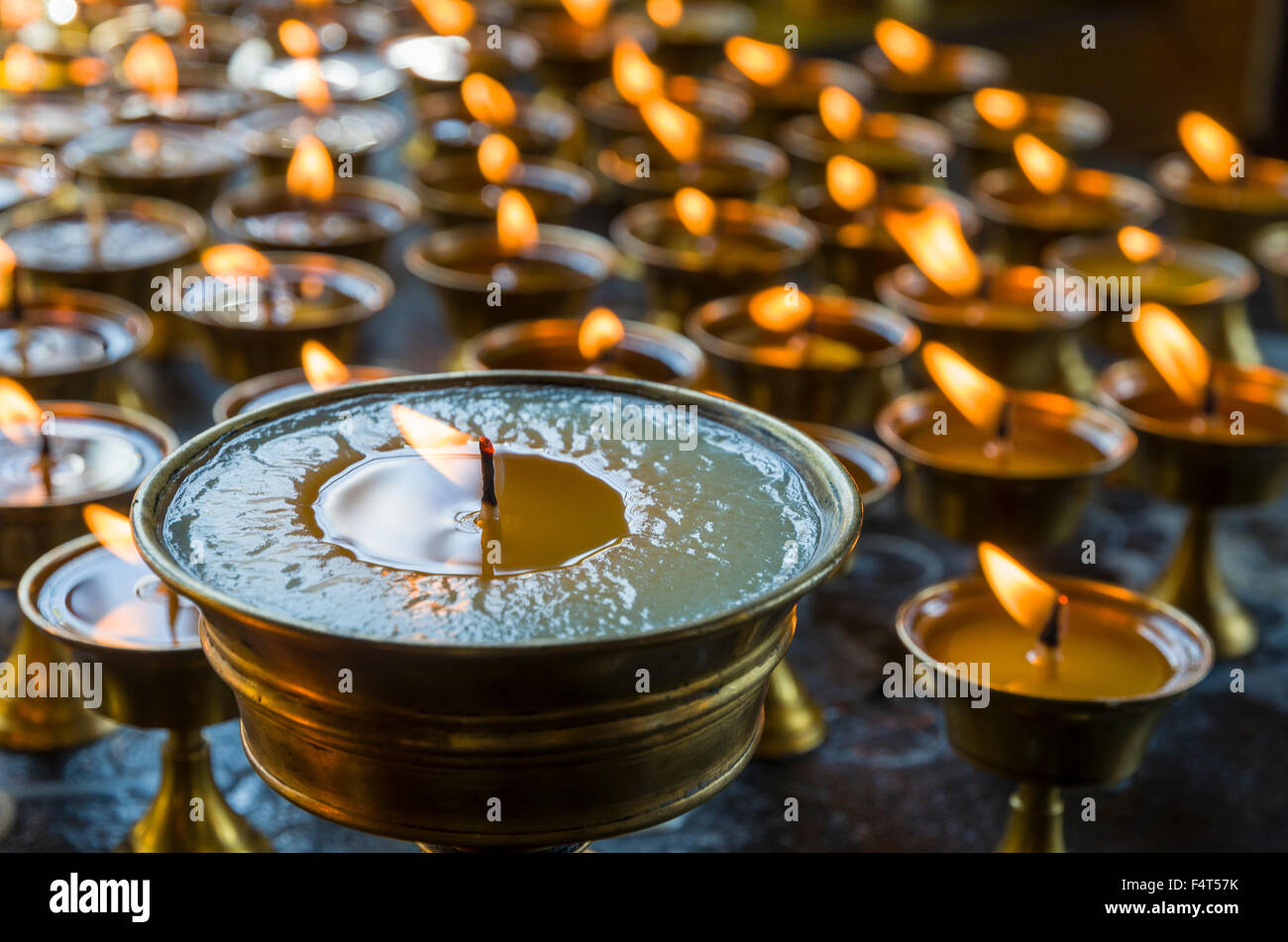 Butter lamps for offerings, lightened Stock Photo - Alamy