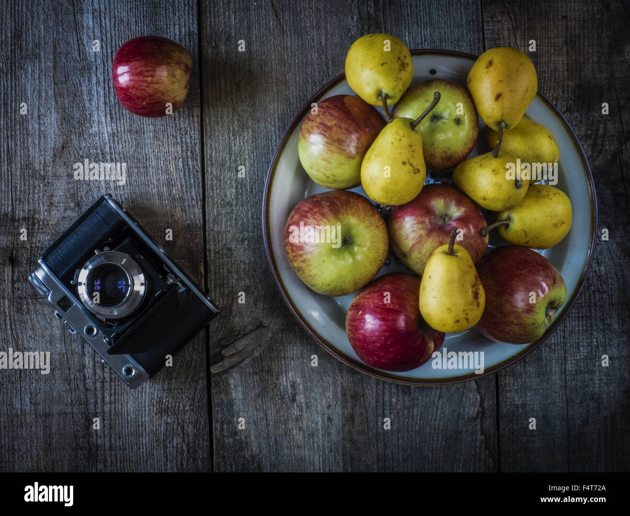 Oct. 19, 2015 - antique photo camera, pears and apples on wooden ...