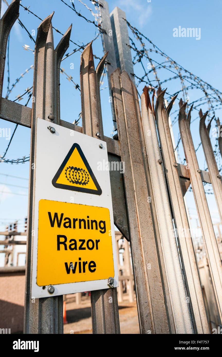 Warning sign on a fence to an electricity power substation warning of ...
