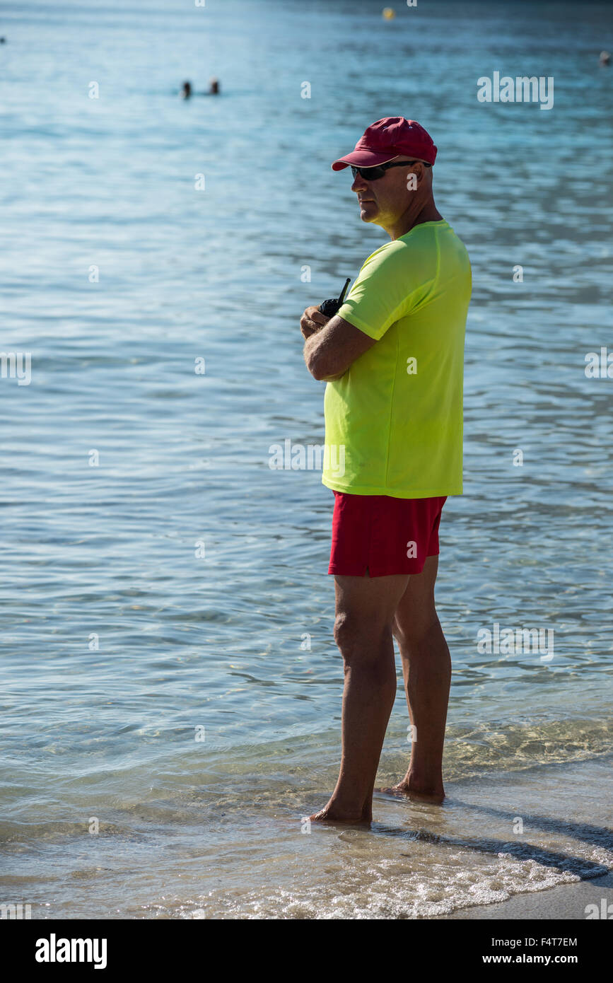 Lifeguard standing on the shore of a beach resort Stock Photo - Alamy