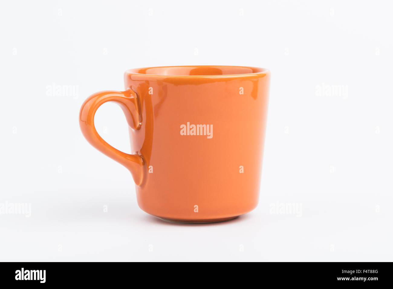 1 Orange cup on white background Stock Photo - Alamy