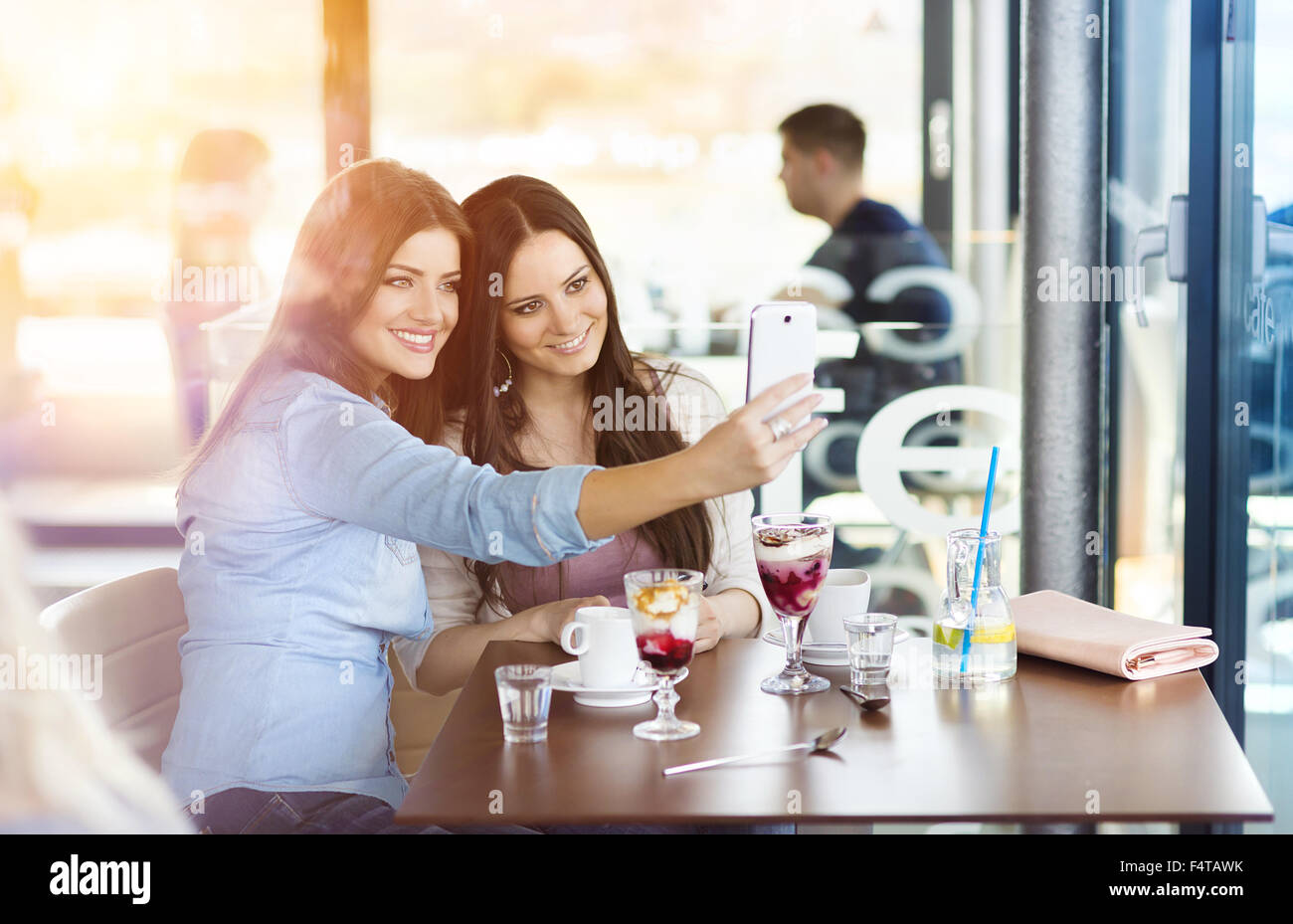 Beautiful women in cafe Stock Photo - Alamy
