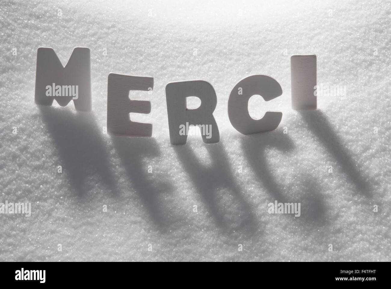 White Word Merci Means Thank You On Snow Stock Photo - Alamy
