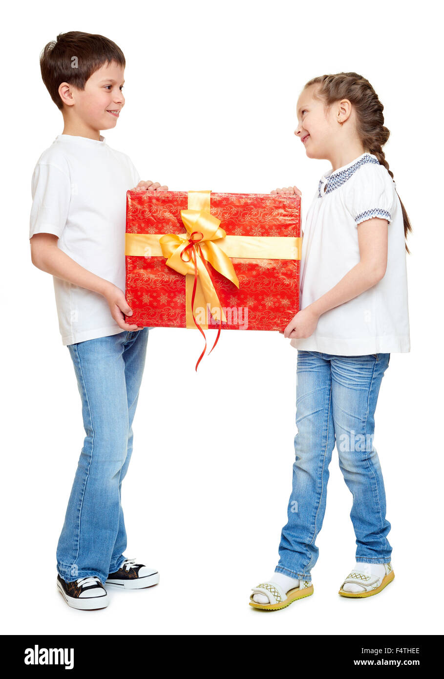boy and girl with red gift box and golden bow - holiday object concept ...