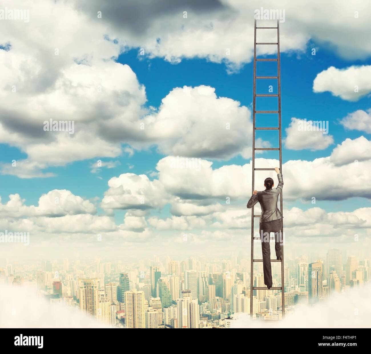 Woman climbing the ladder Stock Photo - Alamy