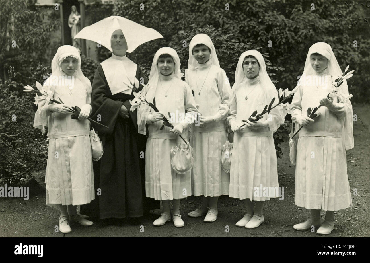 Girls at their first communion with a nun, Italy Stock Photo - Alamy