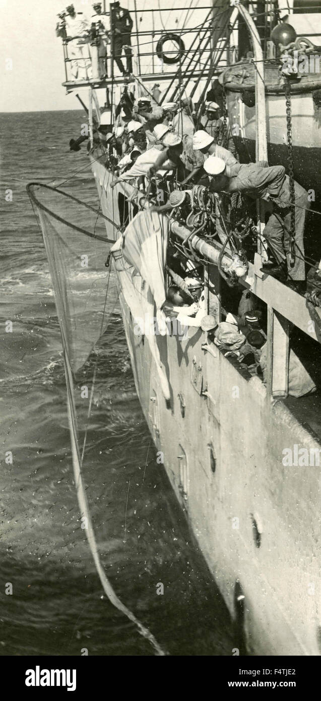 Group of sailors retrieve an object from a ship Stock Photo - Alamy
