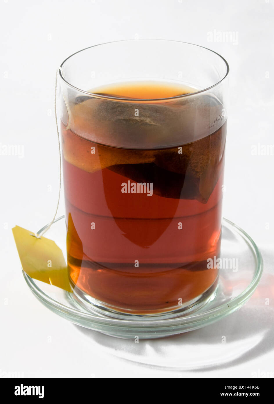 glass of express tea on saucer on white background Stock Photo - Alamy