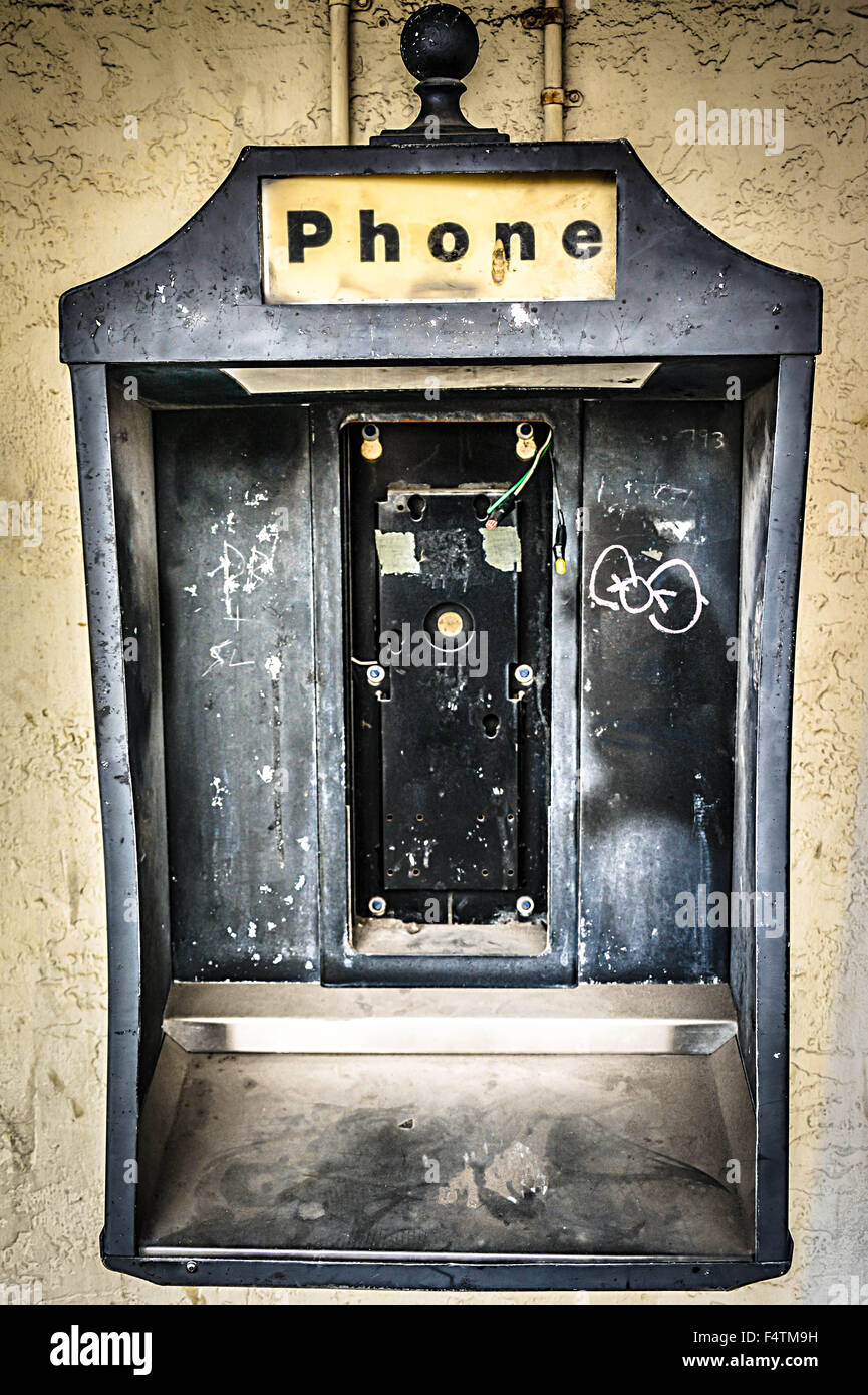 An old fashioned public telephone box with the phone removed, leaving ...