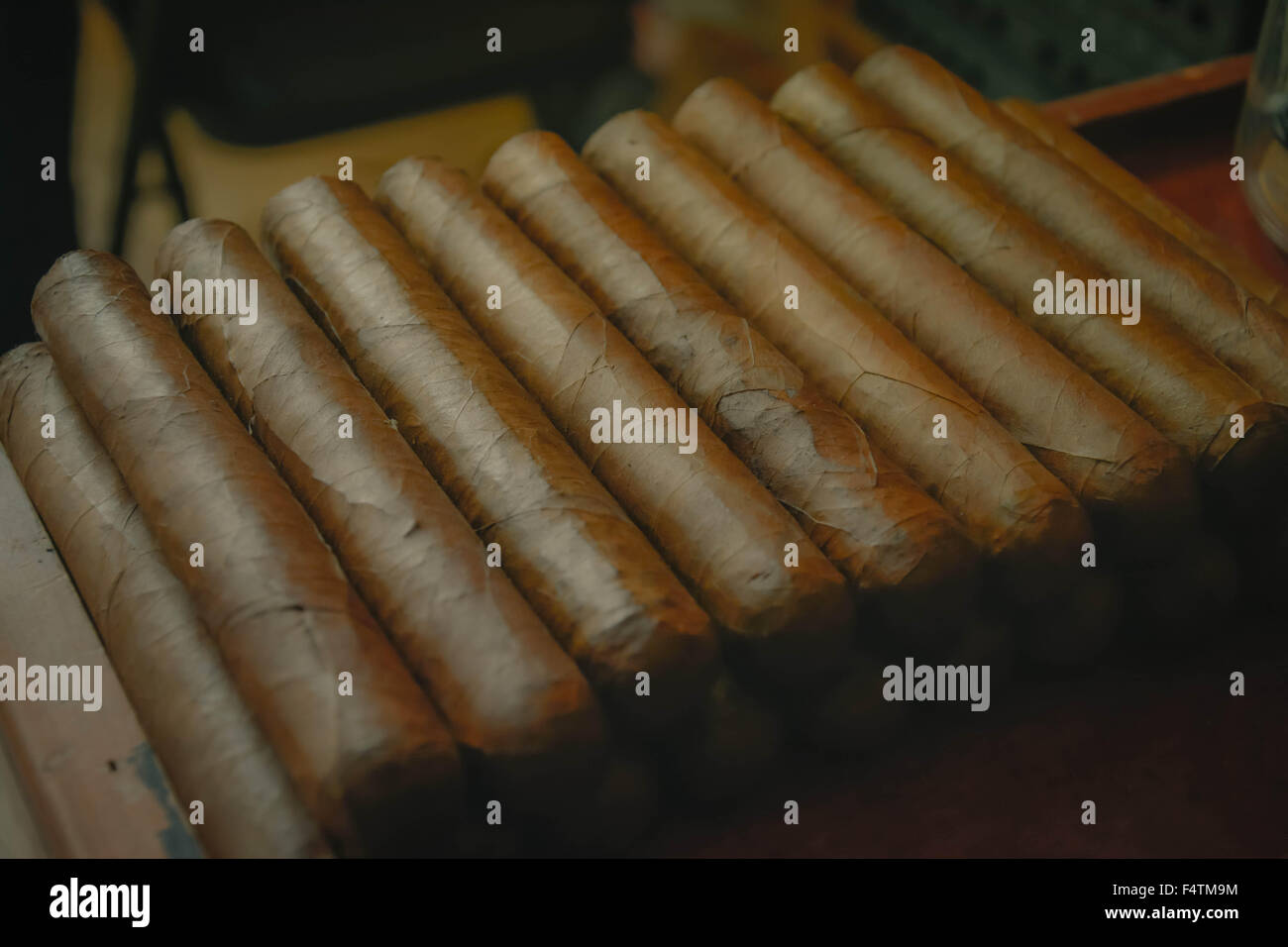 Moody, artistic and nostalgic view of Hand rolled Cuban cigars stacked ...