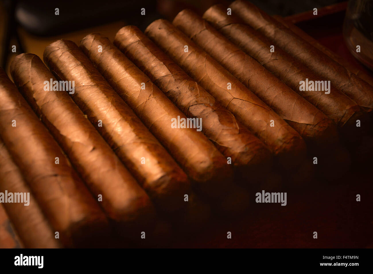 Moody, artistic and nostalgic view of Hand rolled Cuban cigars stacked ...