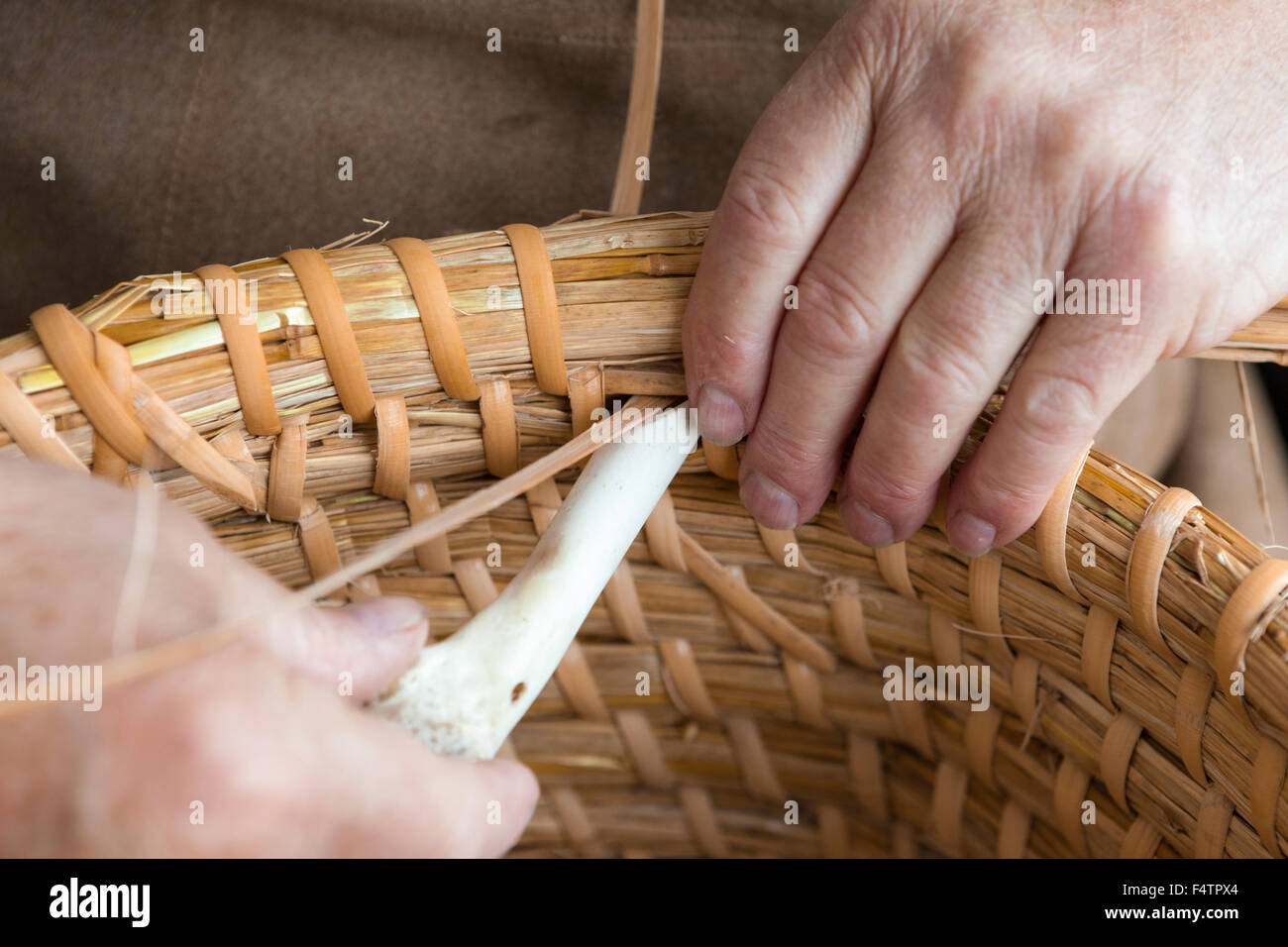 Hand-weaving using traditional bone implements Stock Photo - Alamy