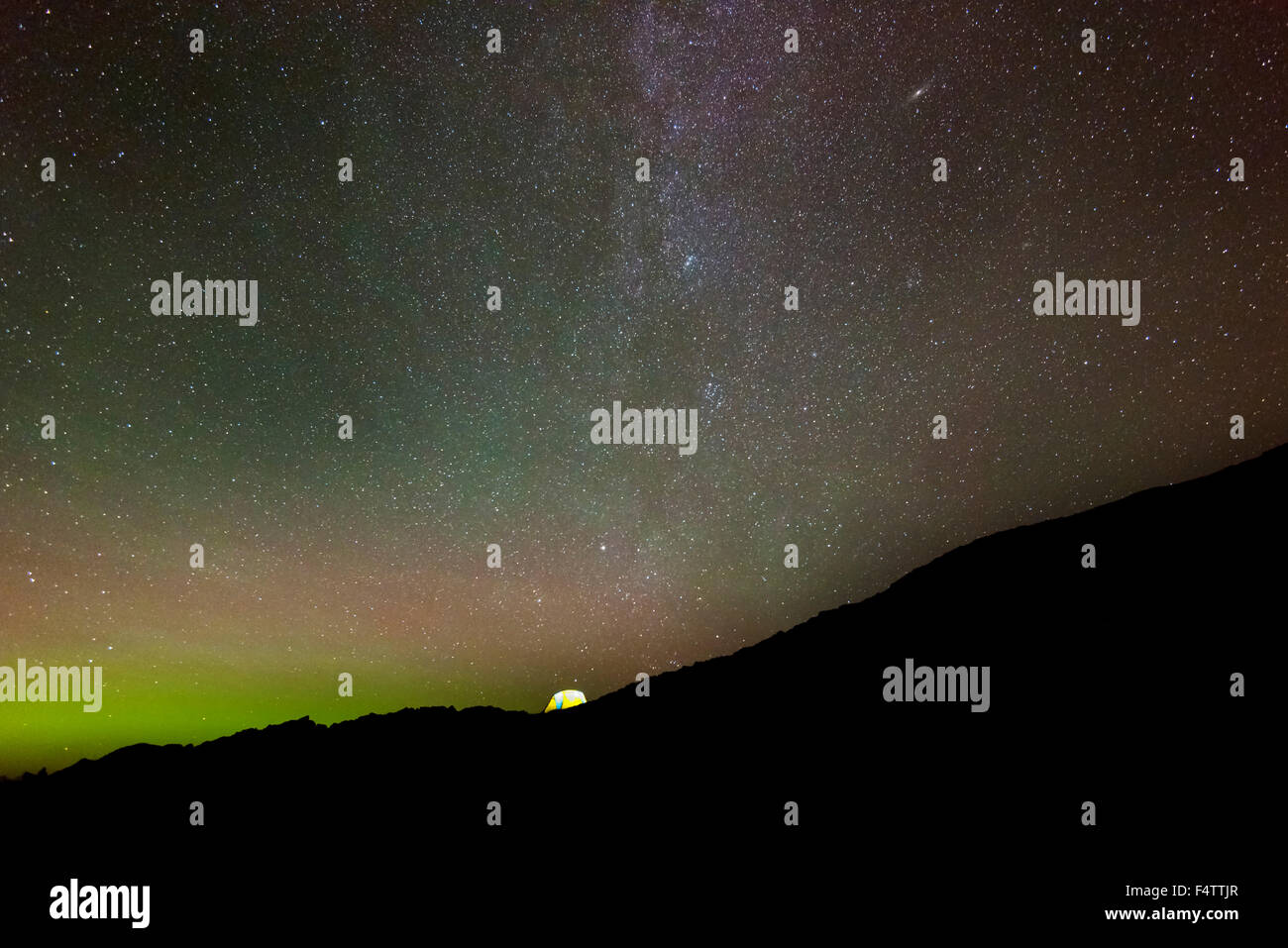 A small tent on the edge of Panorama Ridge during at night of the ...