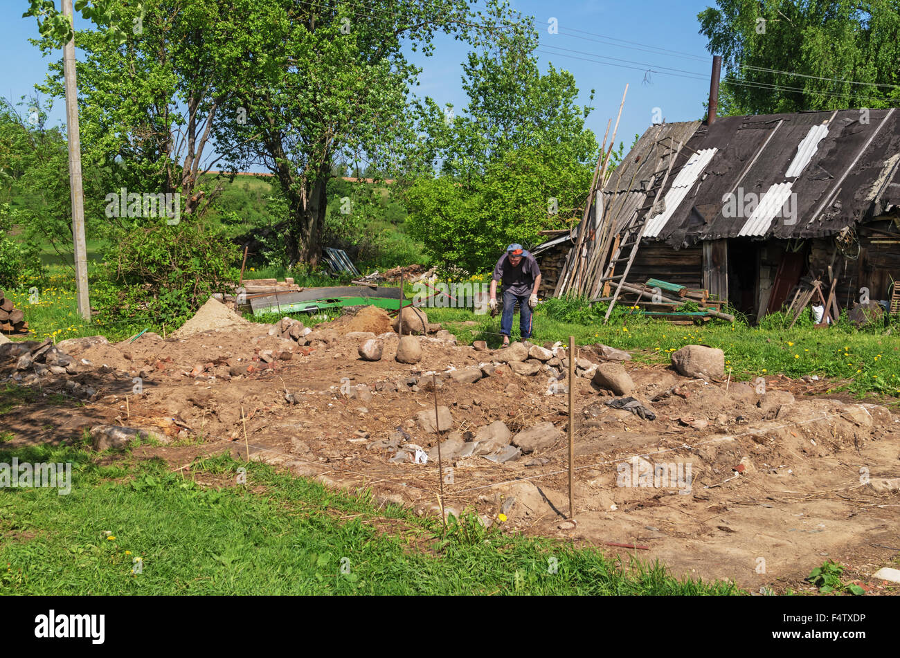 Construction of rural house foundation with use of natural boulders ...