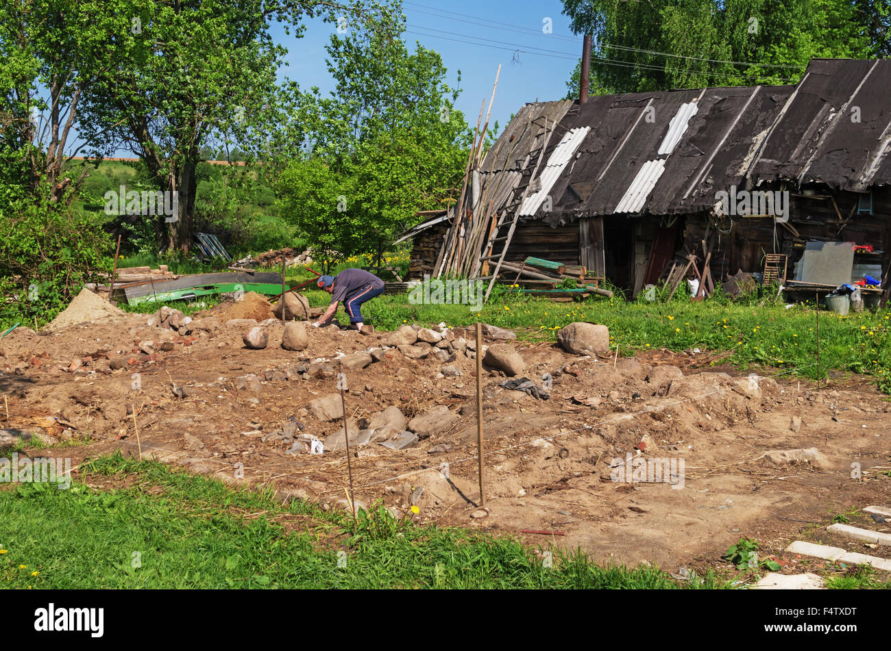 Construction of rural house foundation with use of natural boulders ...