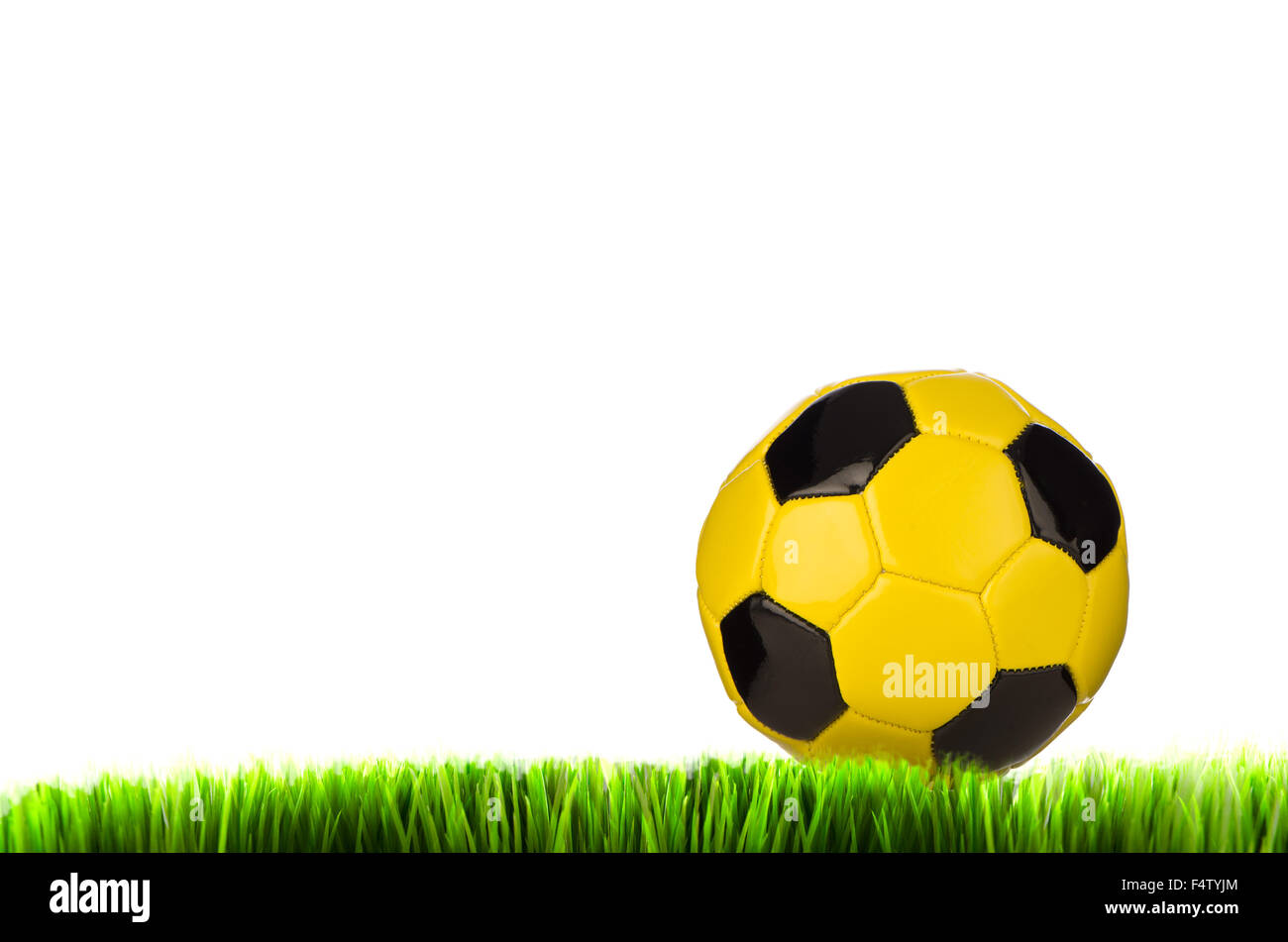 Yellow football on grass field on white bakctround Stock Photo - Alamy