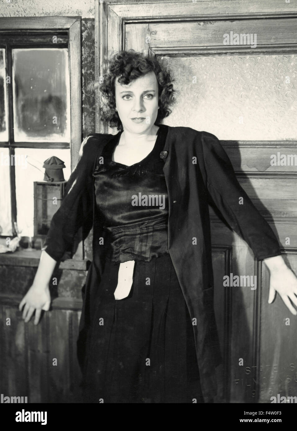 An actress wearing a black dress in a scene from a movie Stock Photo ...