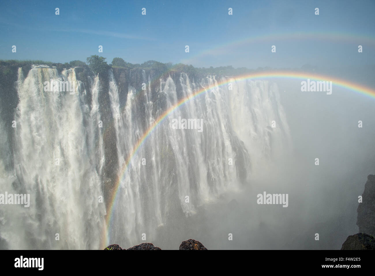 LIVINGSTONE, ZAMBIA - Victoria Falls Waterfall with rainbow Stock Photo ...