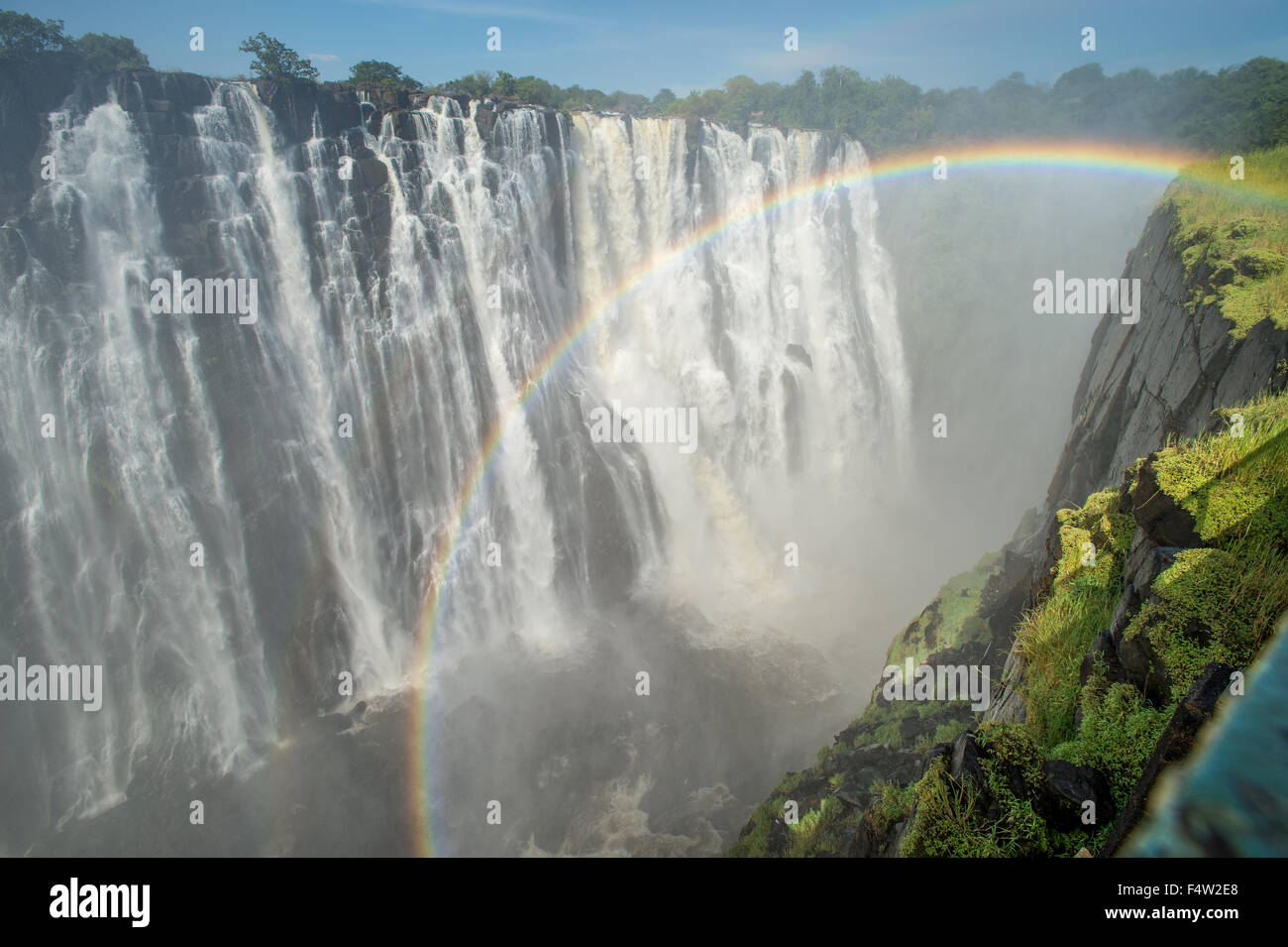 LIVINGSTONE, ZAMBIA - Victoria Falls Waterfall with rainbow Stock Photo ...