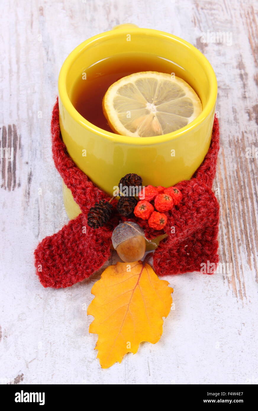 Cup of tea with lemon wrapped woolen scarf, warming beverage for flu ...