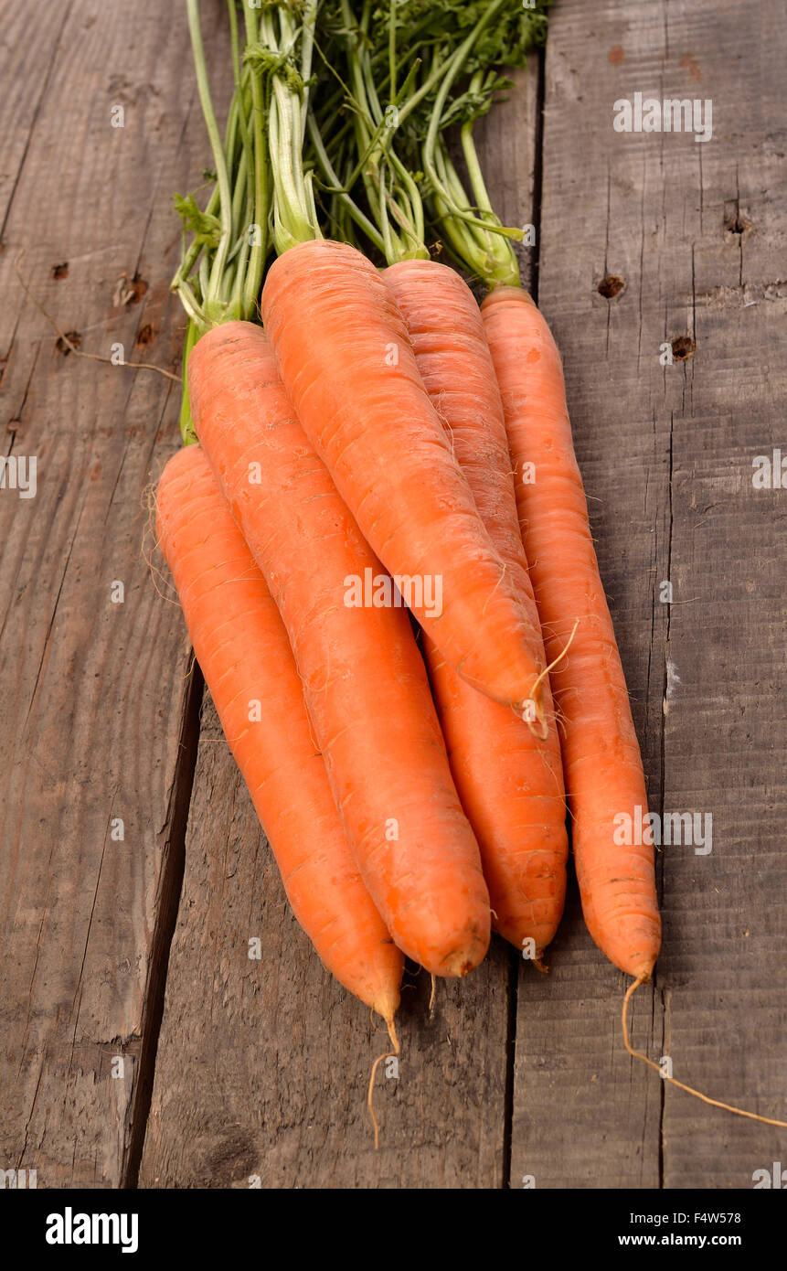 Fresh organic carrots on an old garden table Stock Photo - Alamy