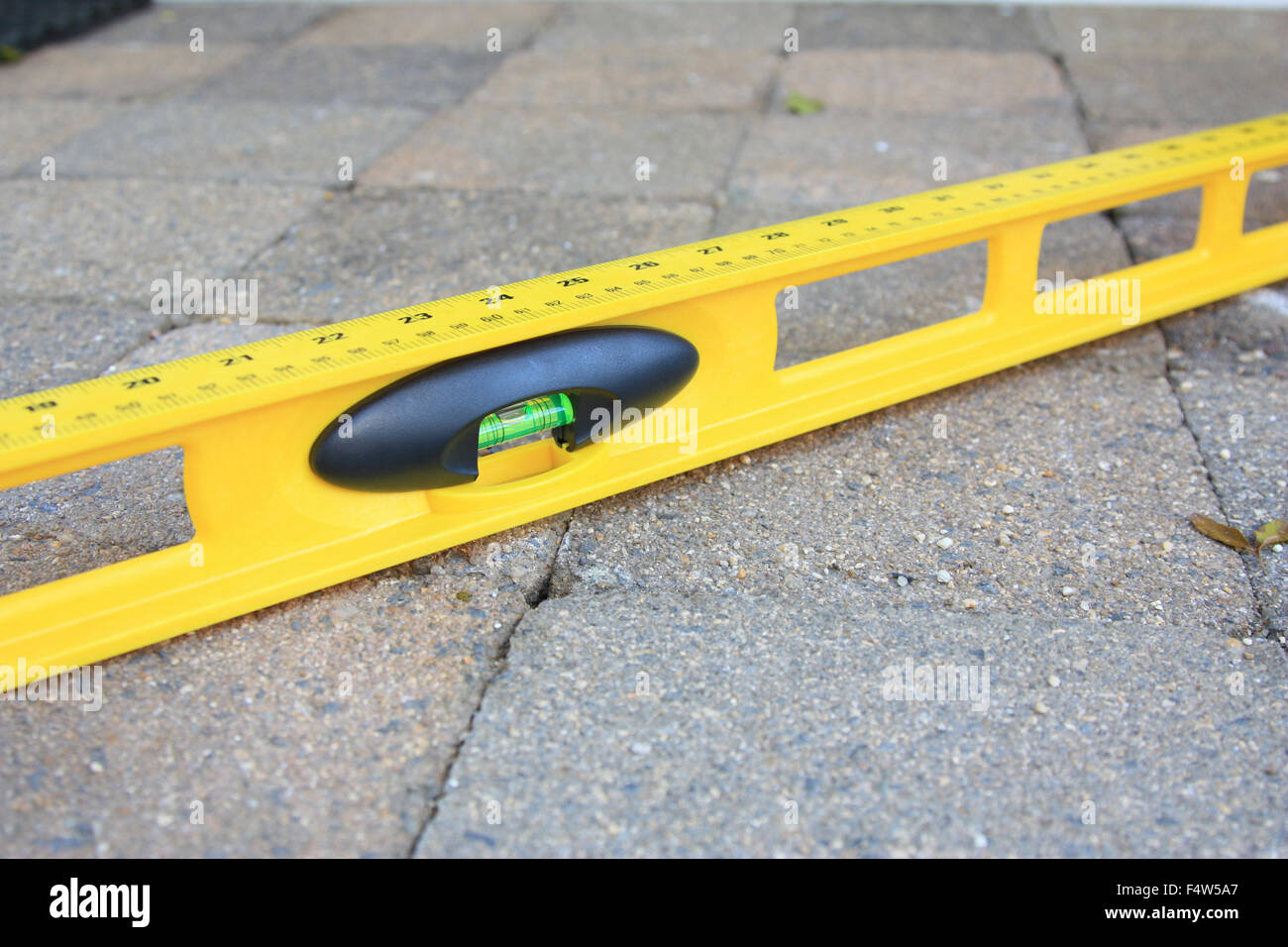 spirit level used to level the paver's or bricks Stock Photo - Alamy