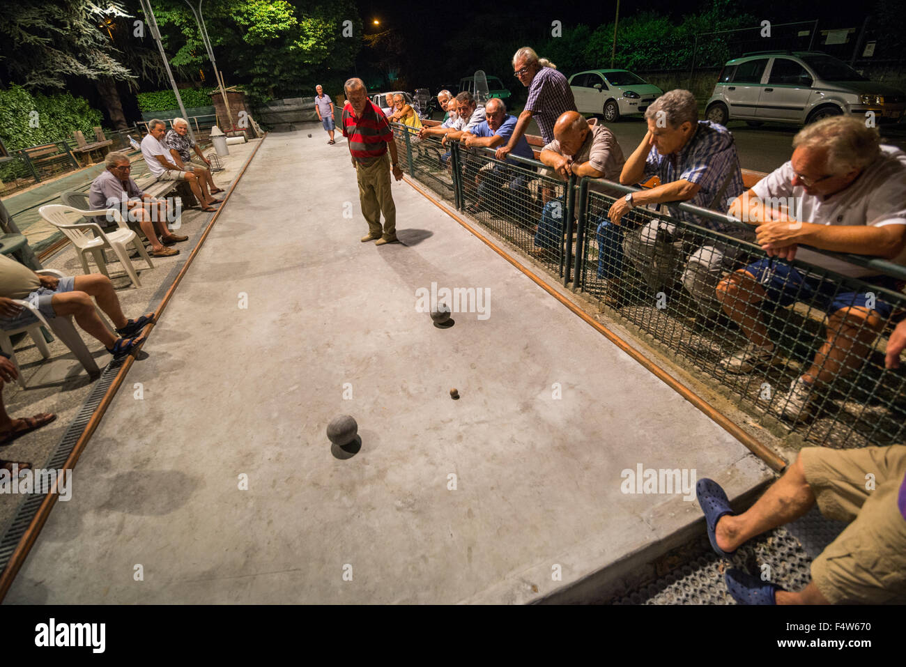 Local men being played bocce ball on outdoor court in Colle di Val d ...