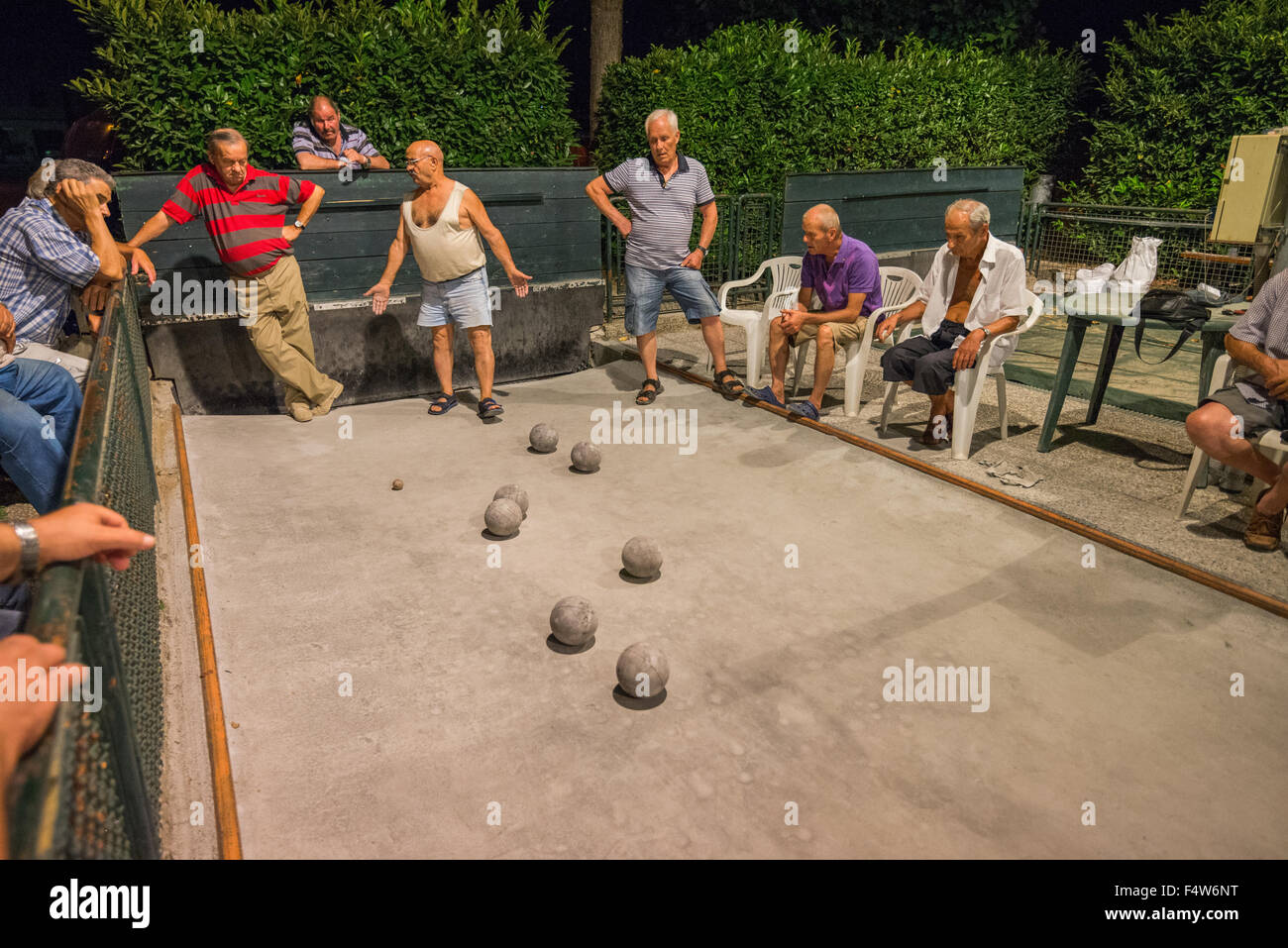 Local men being played bocce ball on outdoor court in Colle di Val d ...
