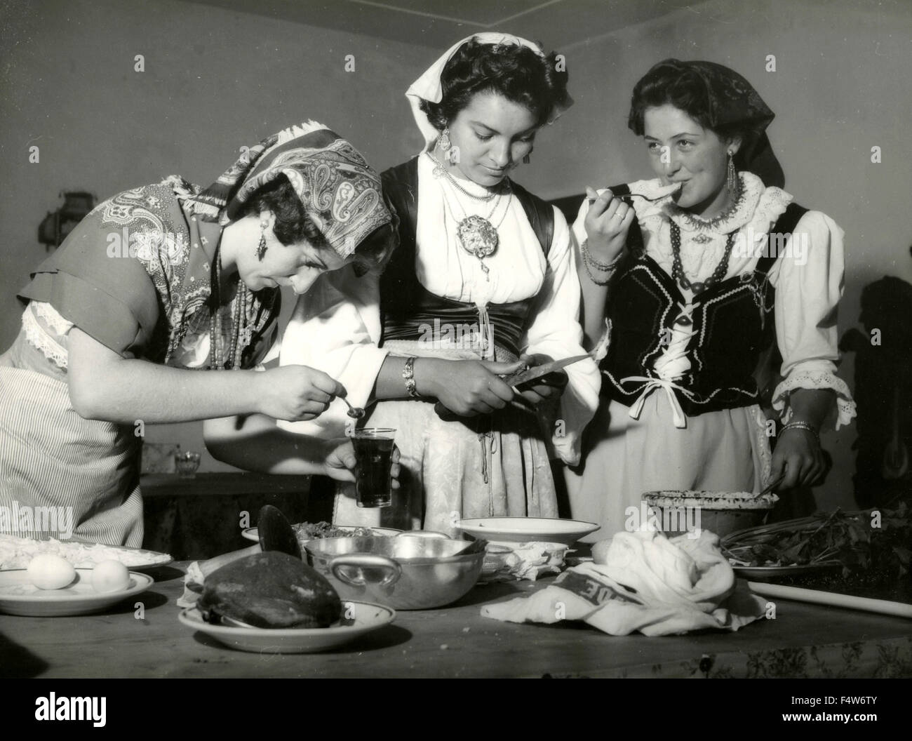 Three women cooking in the traditional costume of Abruzzo, Italy Stock ...
