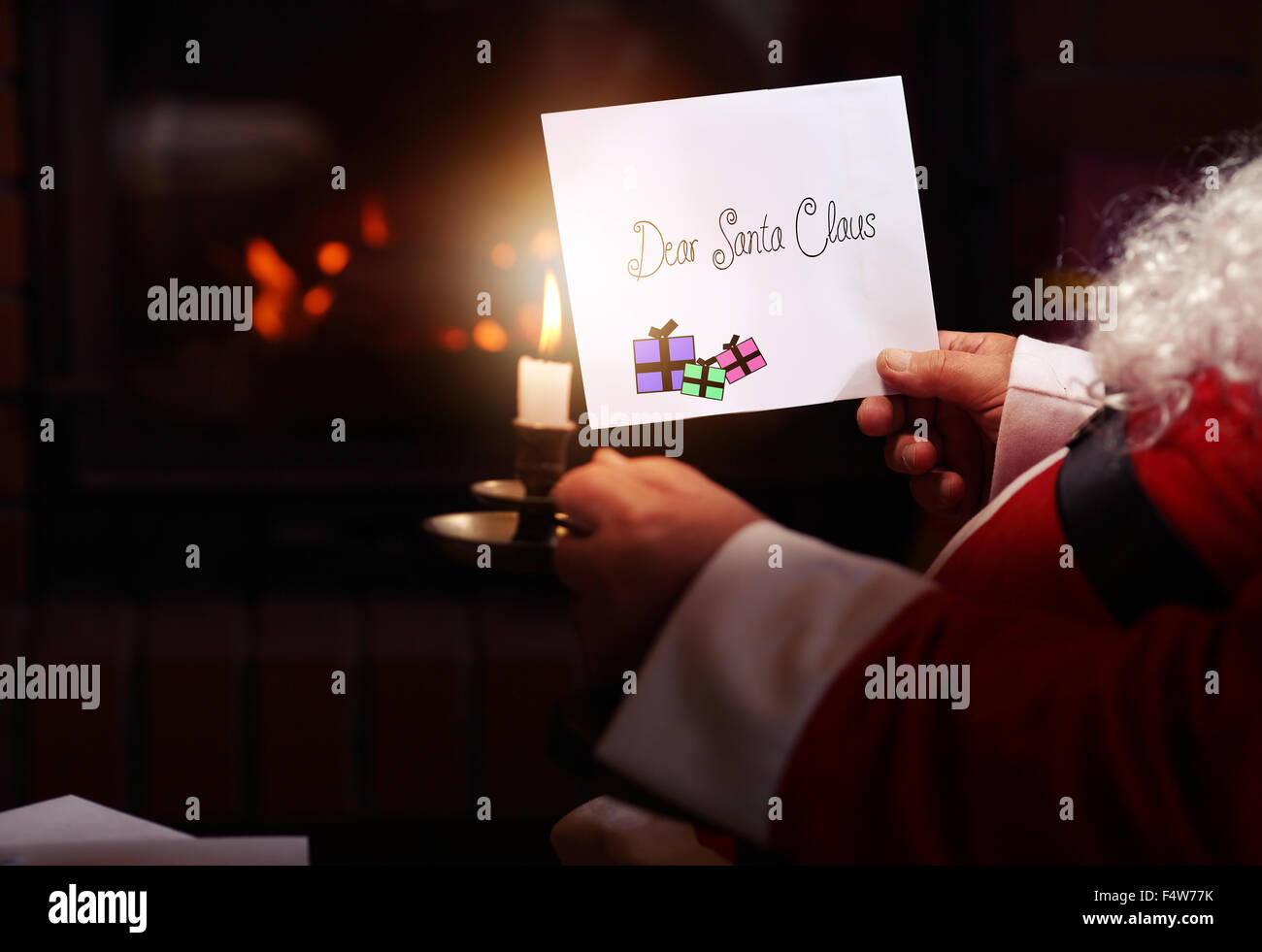 Santa claus reading christmas story hi-res stock photography and images ...