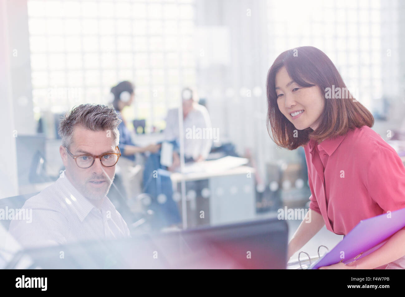 Business people using computer at desk in office Stock Photo - Alamy