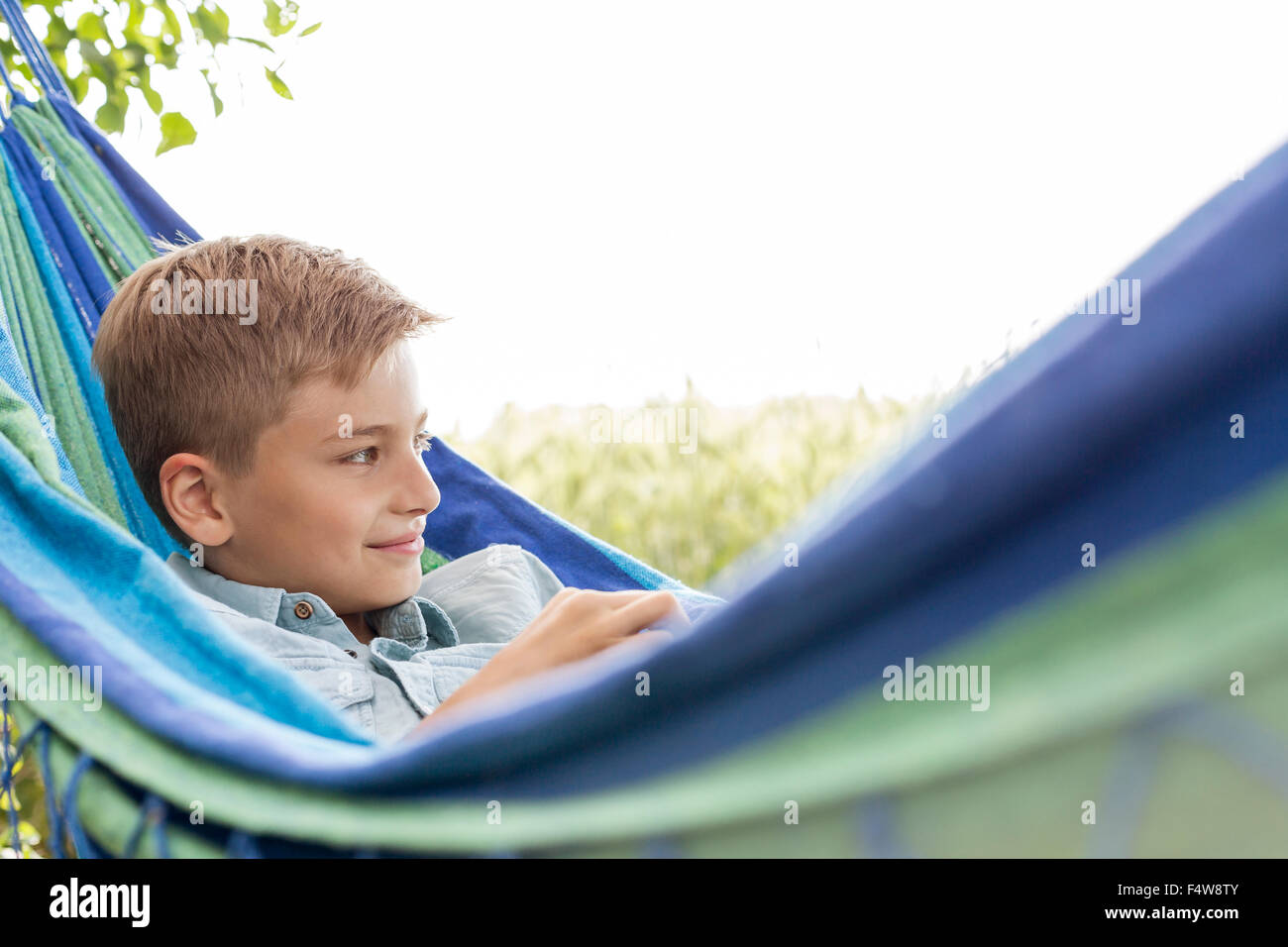 Boy relaxing in hammock Stock Photo - Alamy
