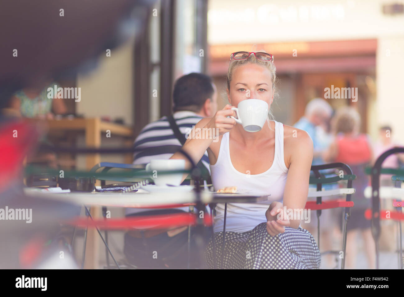 Woman drinking coffee outdoor on street Stock Photo - Alamy