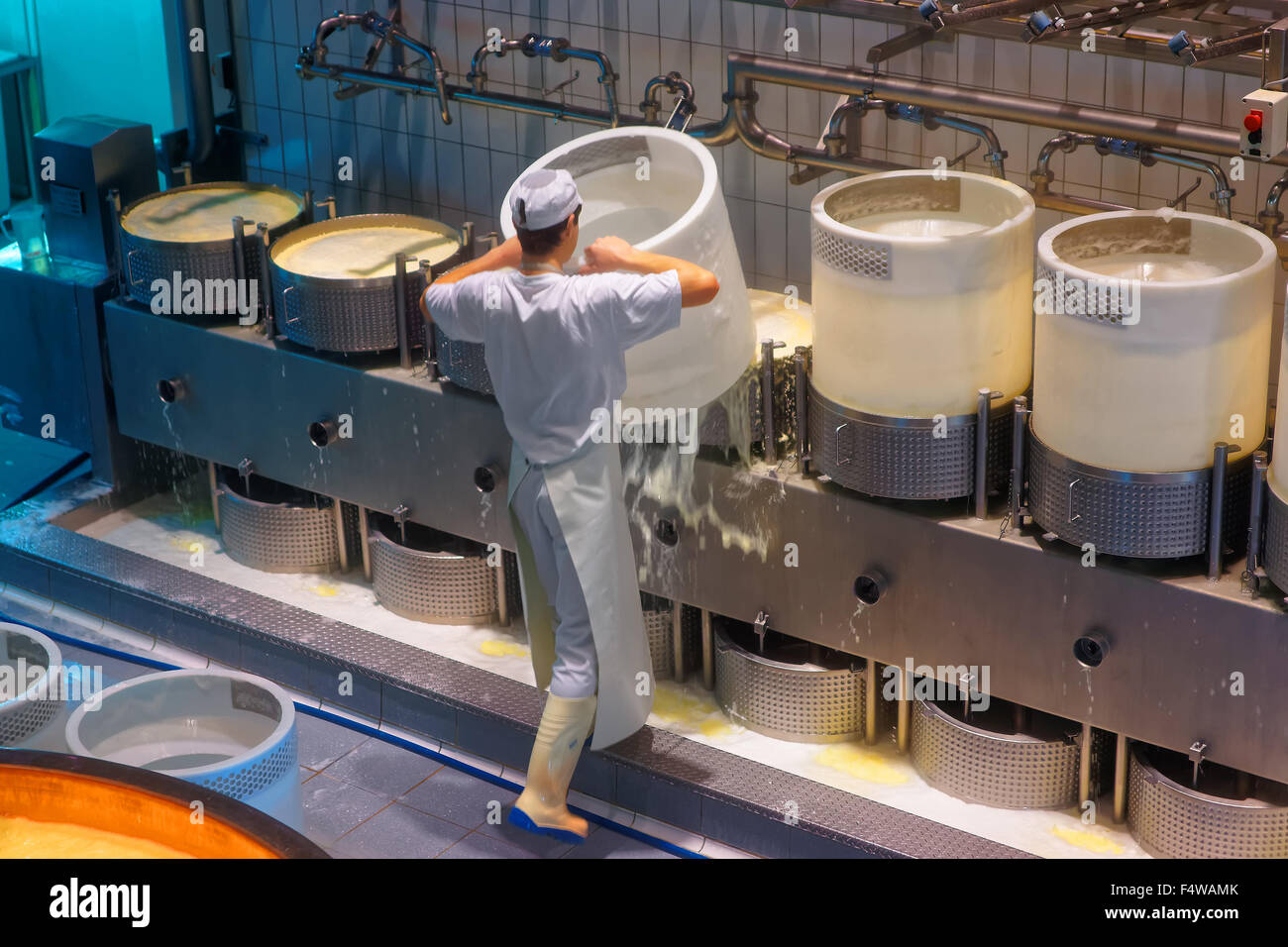 During industrial production of Gruyere cheese at the Maison du Gruyere ...