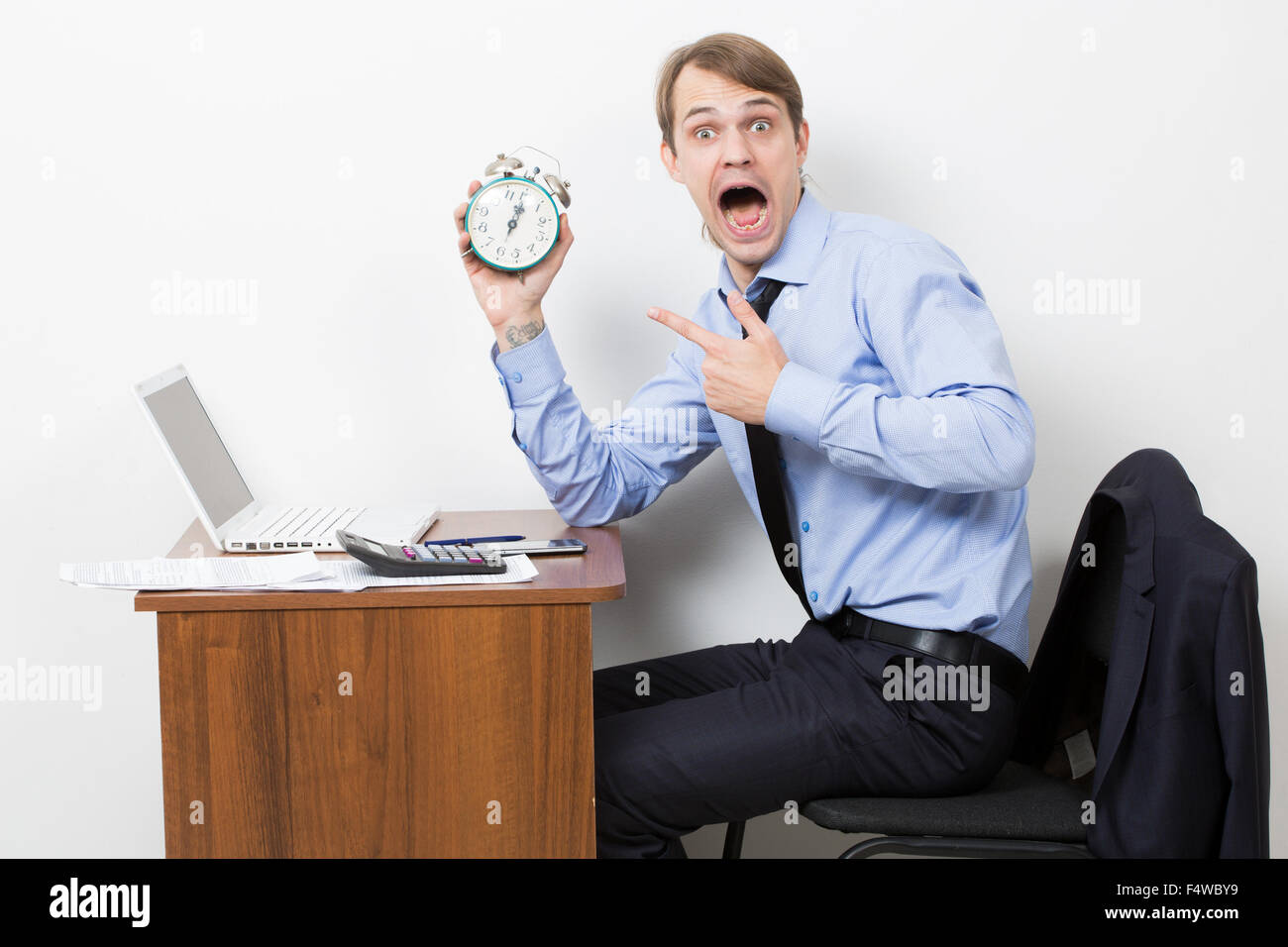 manager shouts at the alarm clock Stock Photo - Alamy