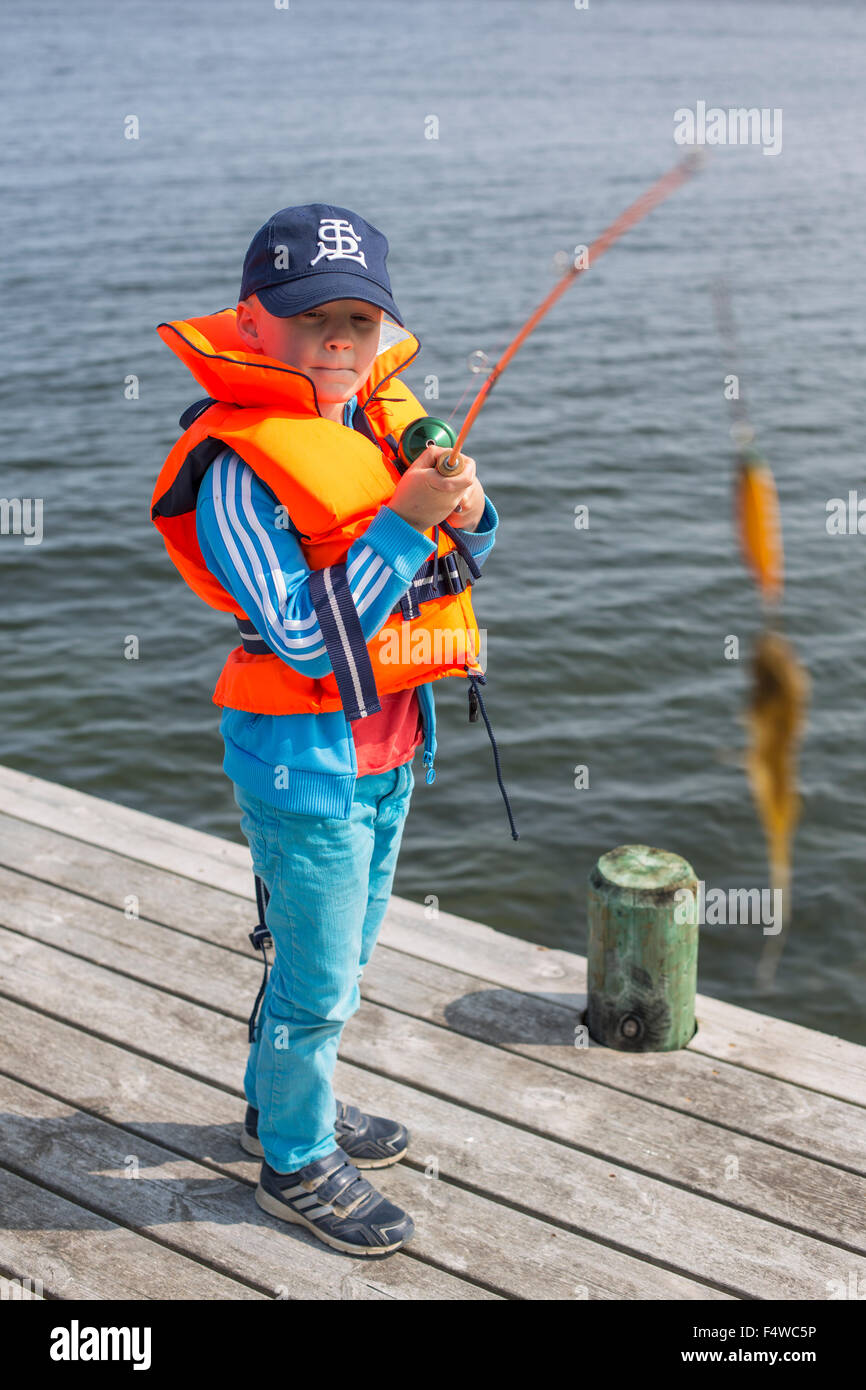 Boy holding fishing rod hi-res stock photography and images - Alamy