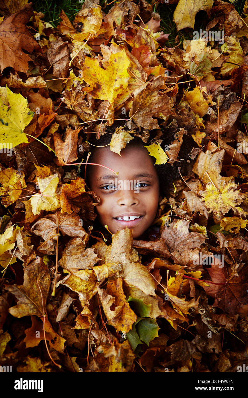 Girl buried in leaves hi-res stock photography and images - Alamy